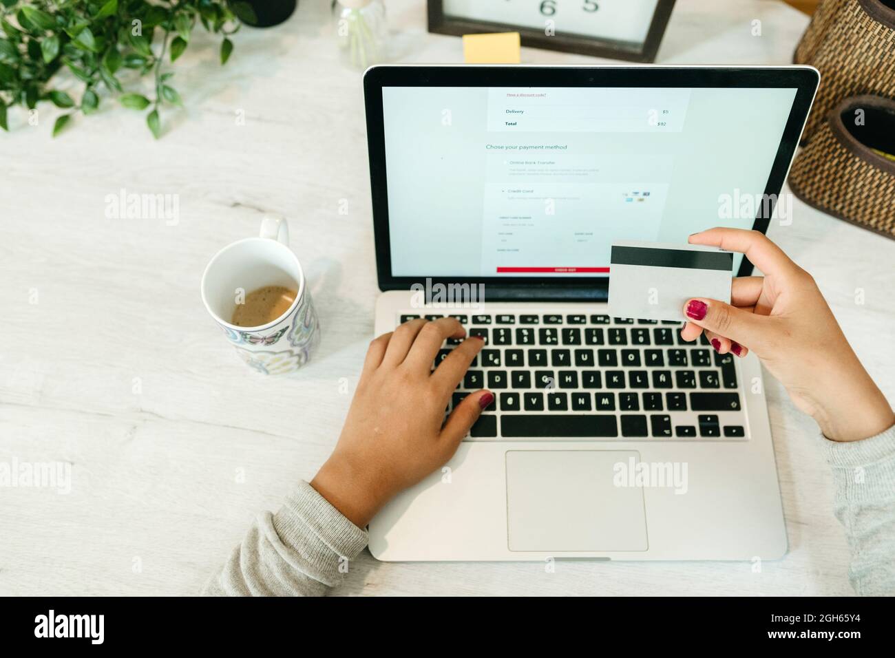 Crop unrecognizable female making purchase with plastic card for order ...
