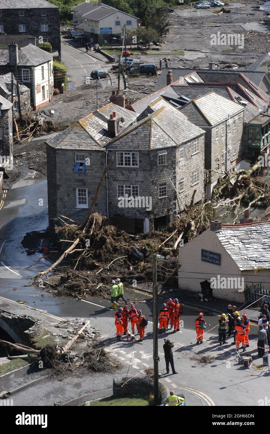 Rescue workers look at the flood devastation after heavy rainfall ...