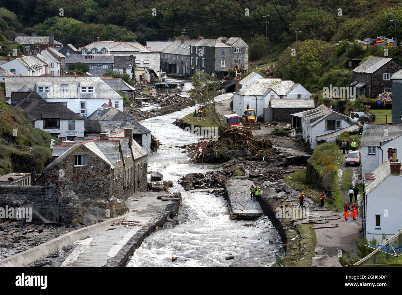 Rescue workers look at the flood devastation after heavy rainfall ...
