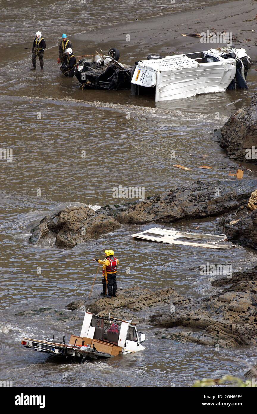 Rescue workers look at the flood devastation after heavy rainfall ...