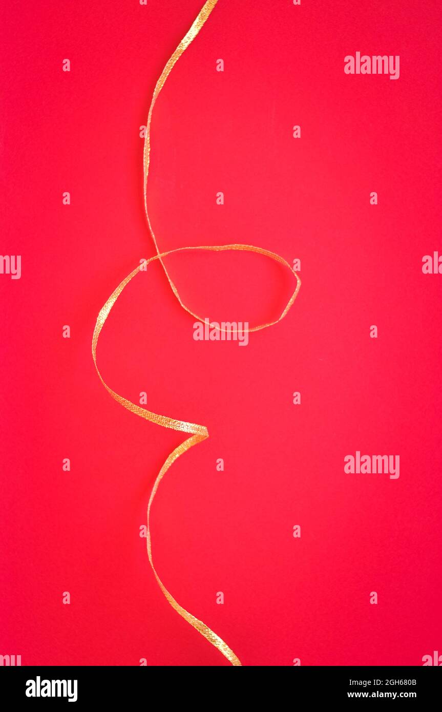 Golden ribbon on red background Christmas wallpaper Stock Photo - Alamy