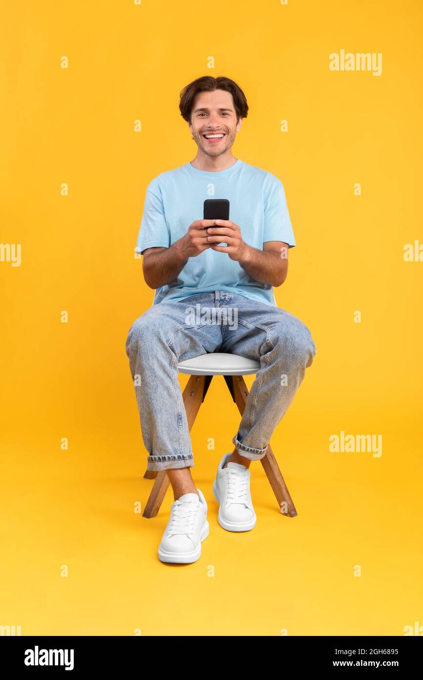Happy guy using mobile hi-res stock photography and images - Alamy