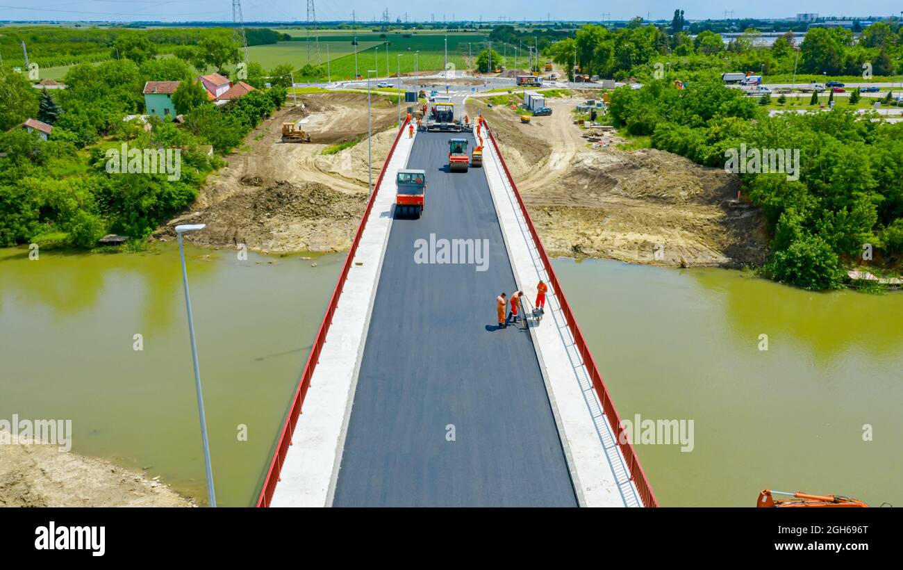Above view, on workers and machinery for laying asphalt, spreading ...