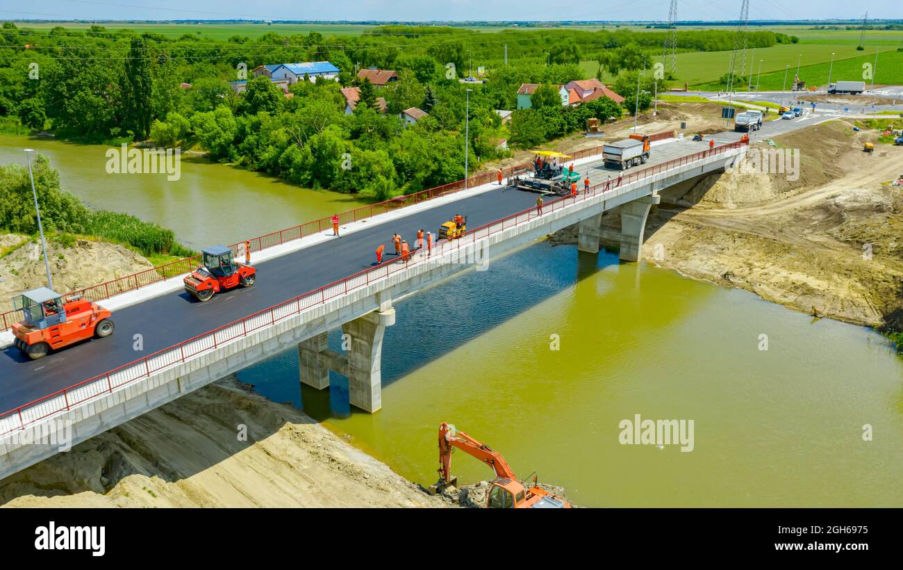Above view, on workers and machinery for laying asphalt, spreading ...