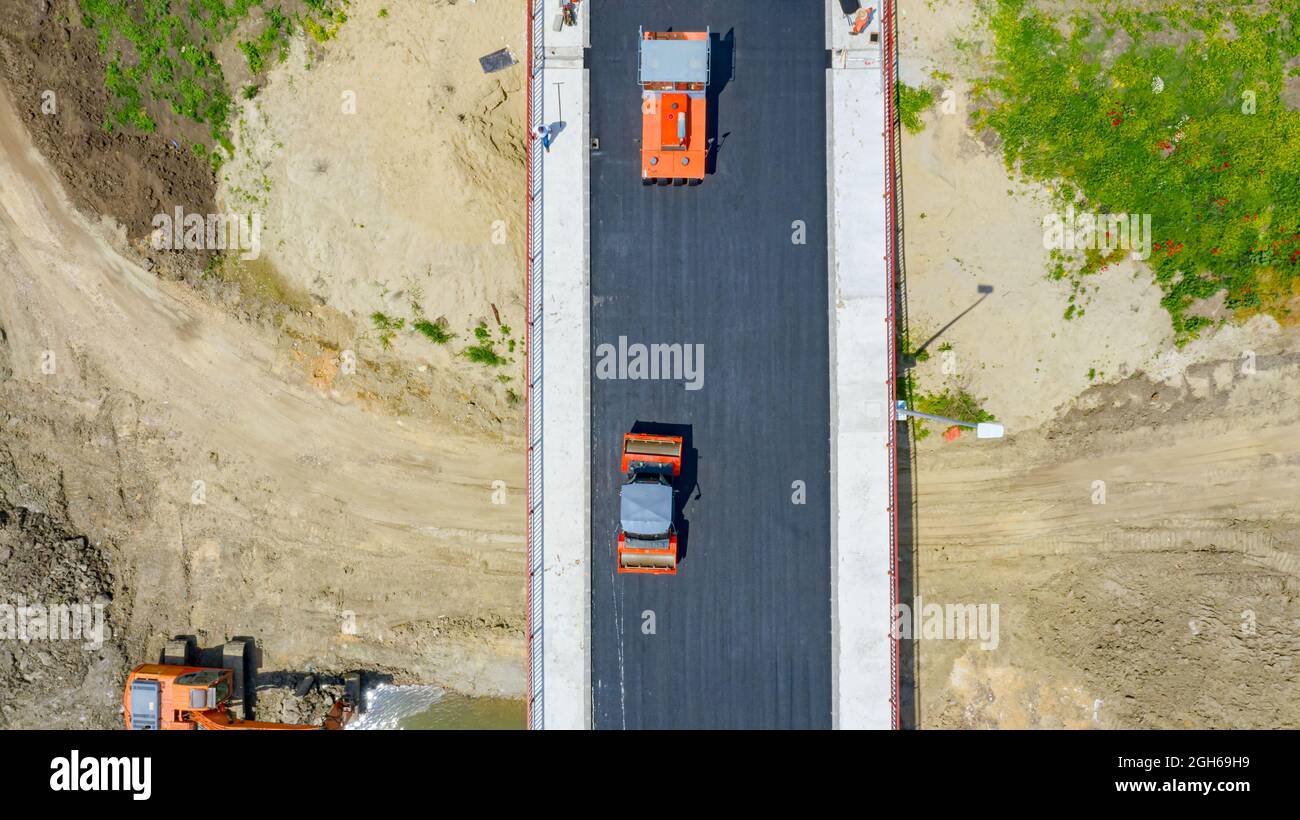 Above top view, overhead, on several steamrollers as flatting fresh ...