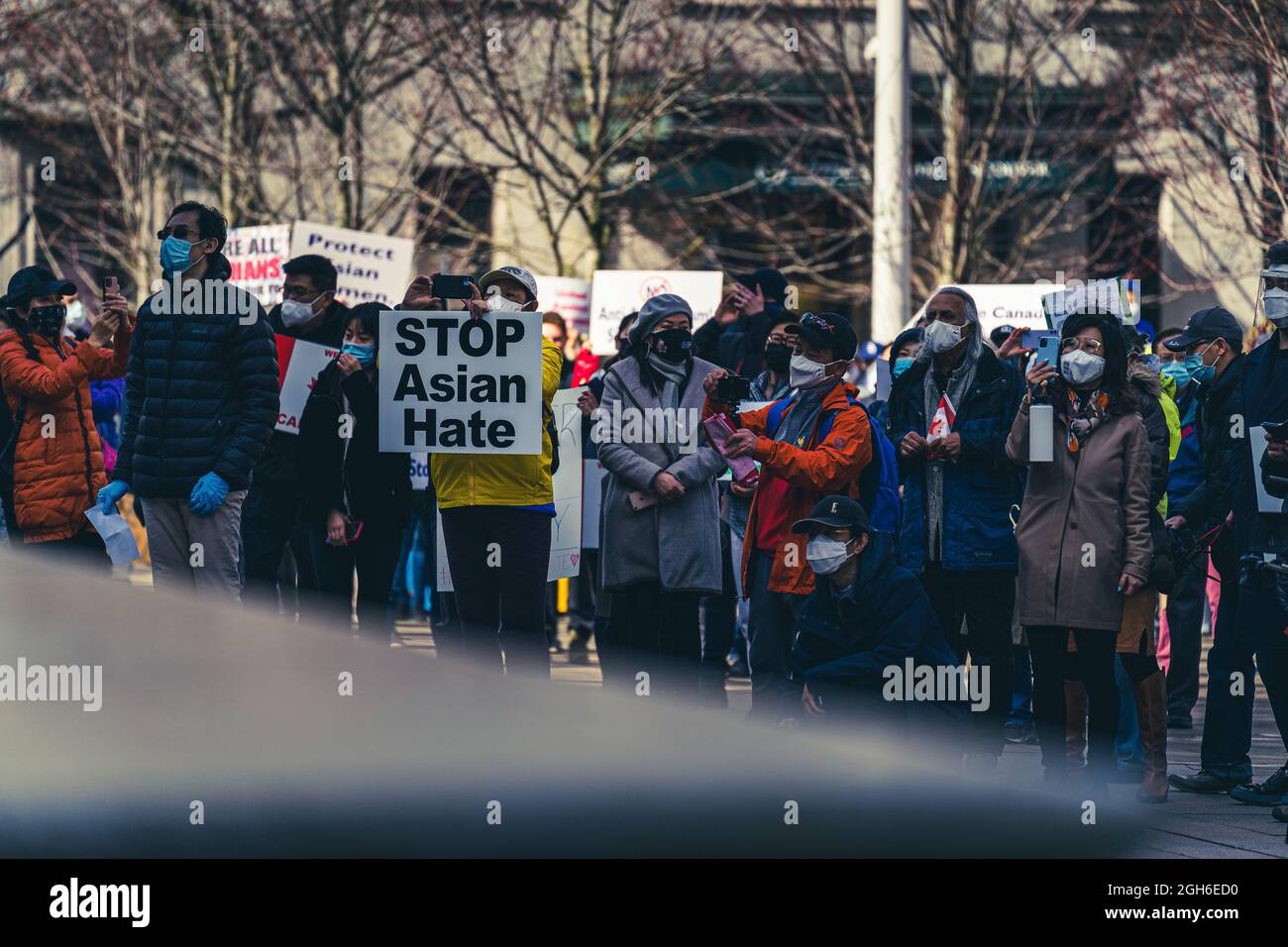 VANCOUVER, CANADA - Apr 12, 2021: The people holding up signs at a Stop ...
