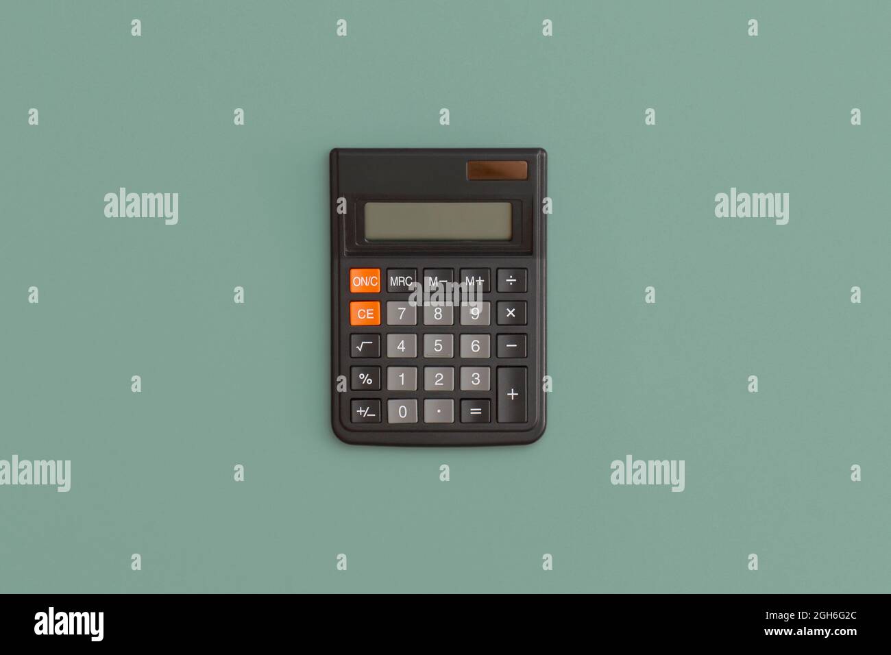 Calculator on green background. Back to school Stock Photo - Alamy