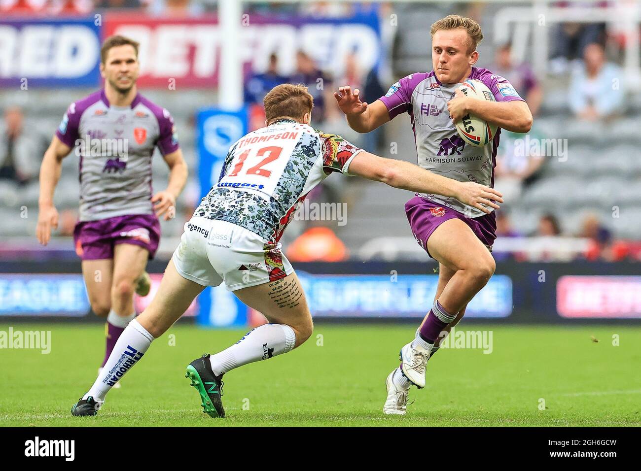 Jez Litten (14) of Hull KR evades the tackle of Jordan Thompson (12) of ...