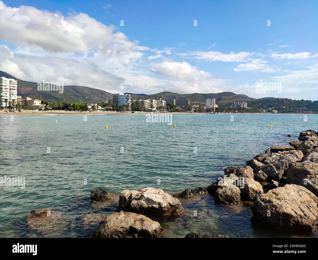 Beach with crystal clear water of the Mediterranean Sea next to a stone ...