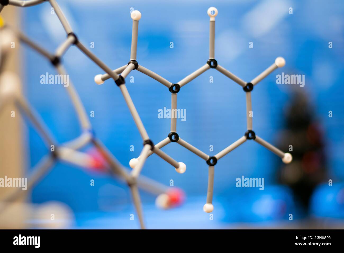An assembly of comples organic molecule structure with blur background ...