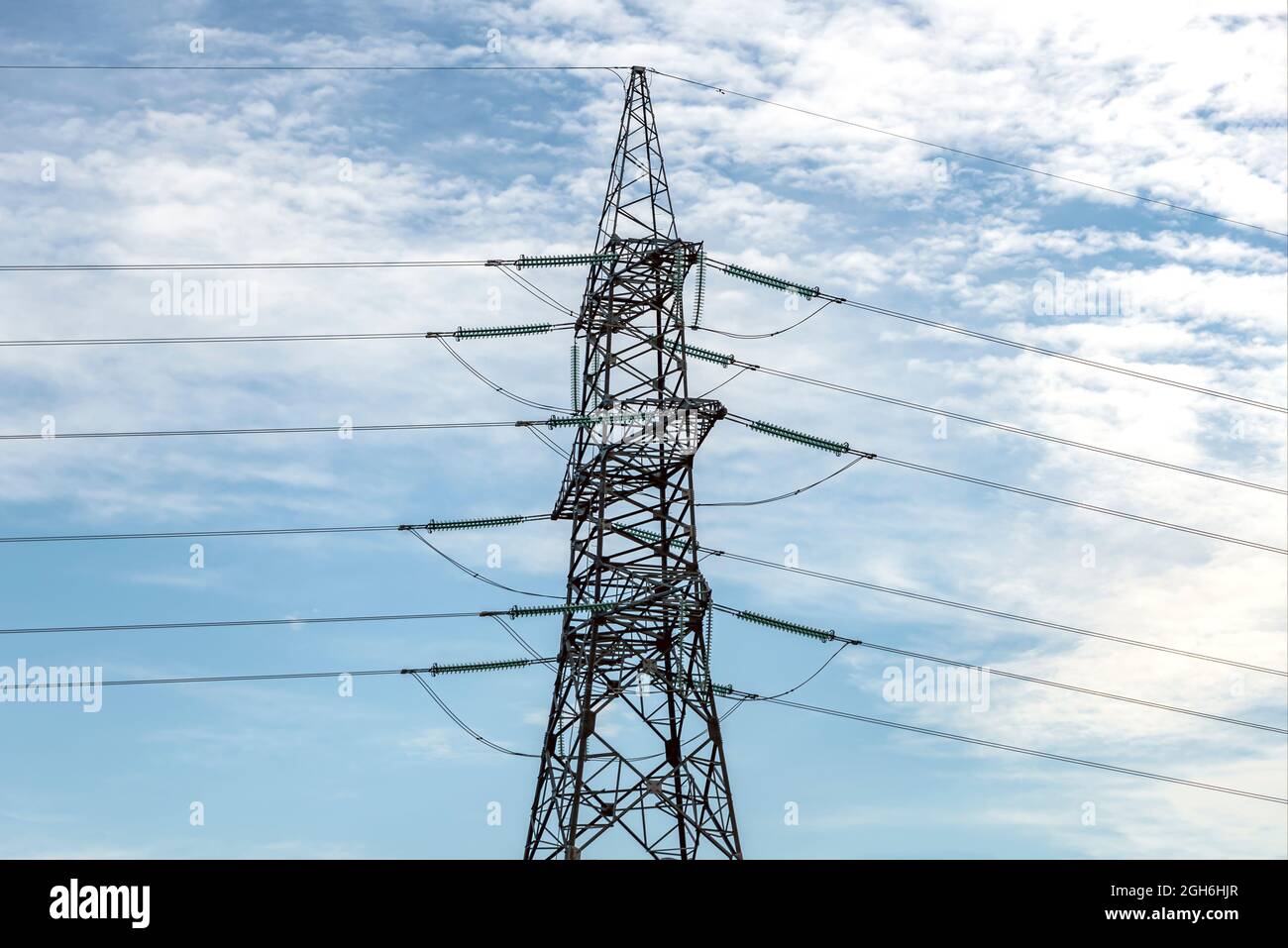 High voltage pillar. Power grid pole against the sky. High voltage ...