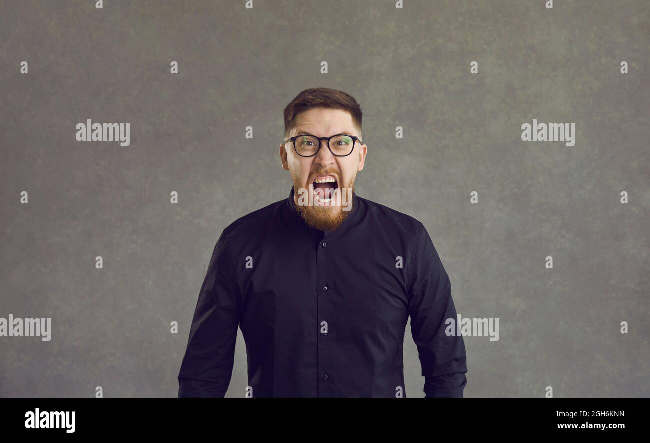 Crazy and furious Caucasian man in a rage shouts loudly and angrily ...