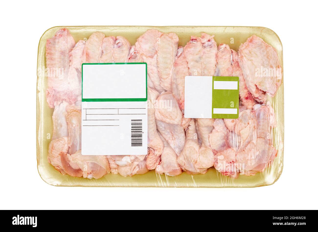 Raw chicken wings packed in a styrofoam plate with a label on white ...