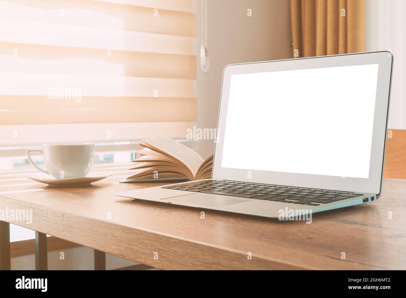 Laptop computer blank empty mock up screen in home office interior, working from home concept ...