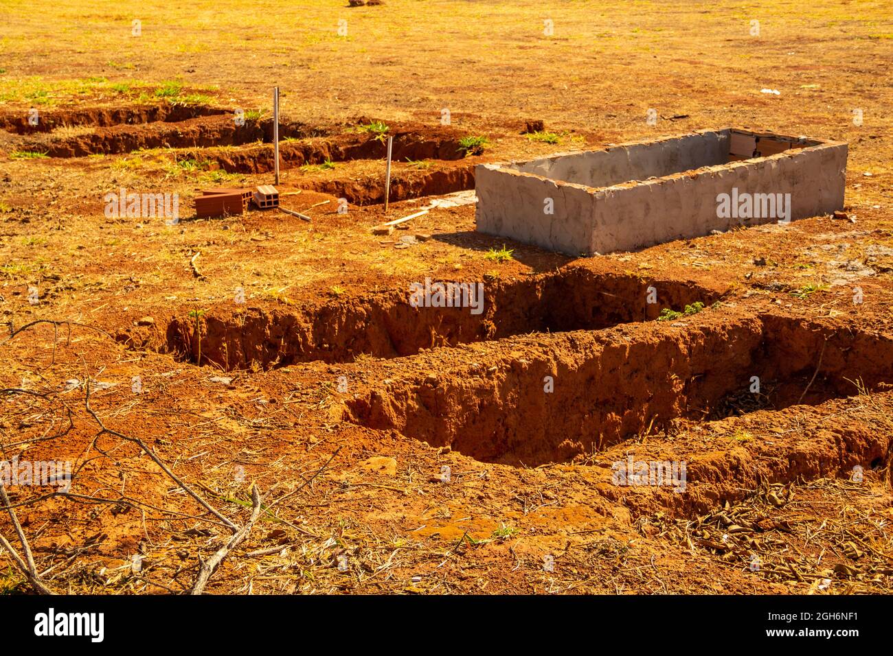 Details of open graves in a cemetery. Holes drilled in the ground for ...