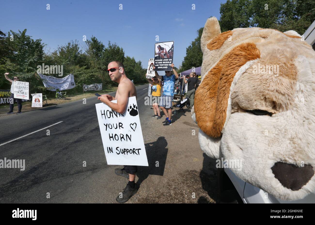 Protesters hold up signs to get support from passing motorists during ...