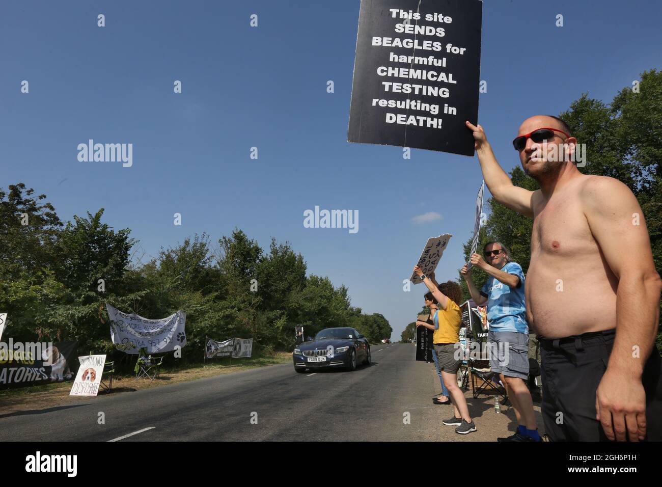 Protesters hold up signs to get support from passing motorists during ...