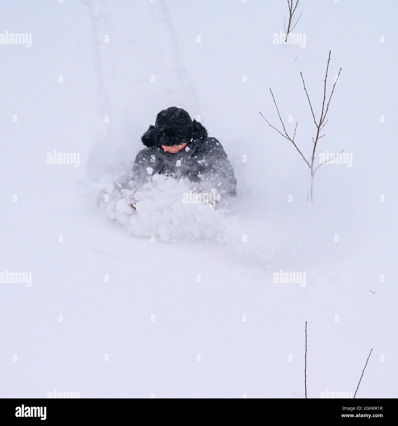 The guy is sledding down the hill, winter joys when it's snowing in the ...