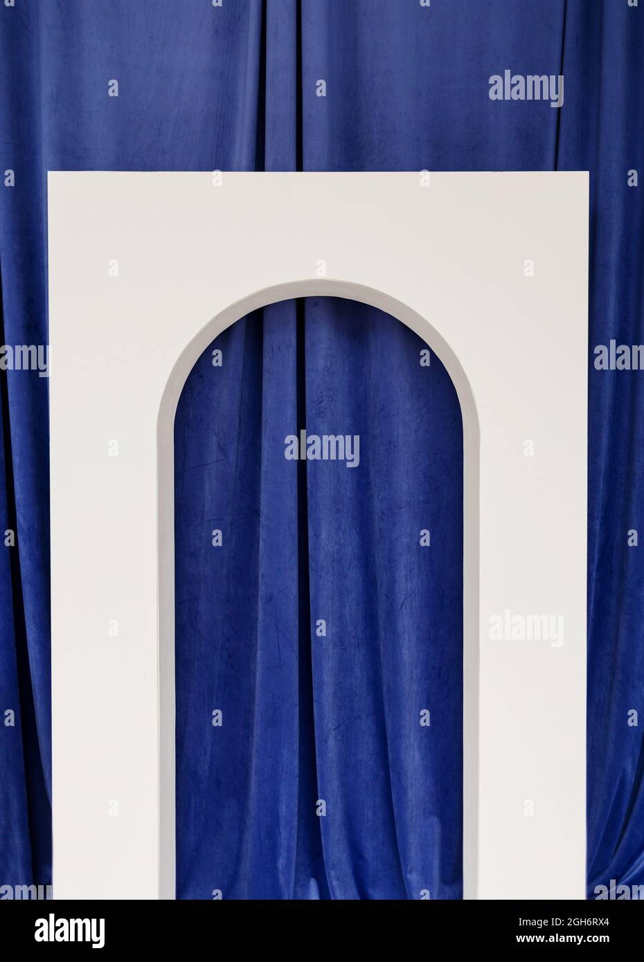 Interior design and decoration. Arch with blue textile Stock Photo - Alamy