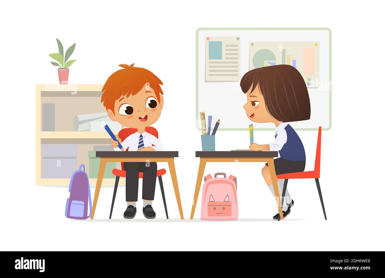 Cheerful elementary classmates wearing school uniform talking at lesson ...