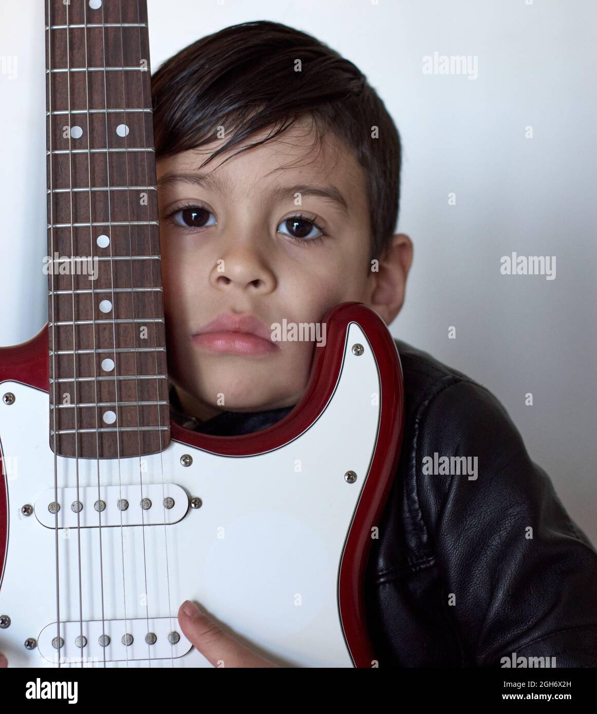 closeup portrait latin boy posing bored with his face resting on his ...