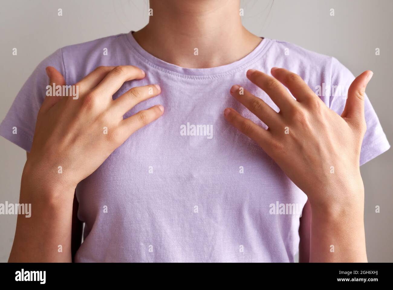 Young teenage girl practicing EFT or emotional freedom technique ...