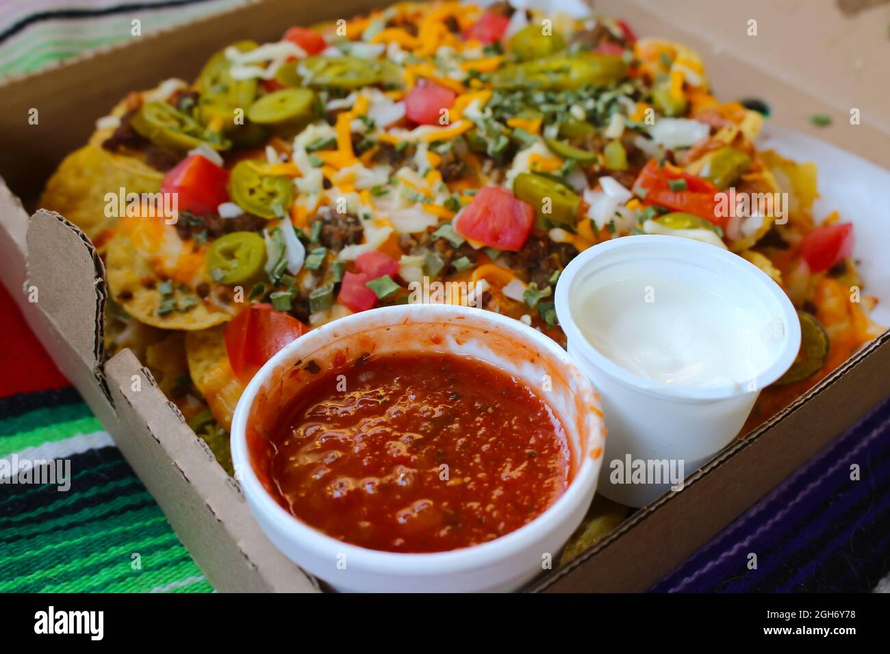 Delicious take out nachos with salsa dip Stock Photo - Alamy