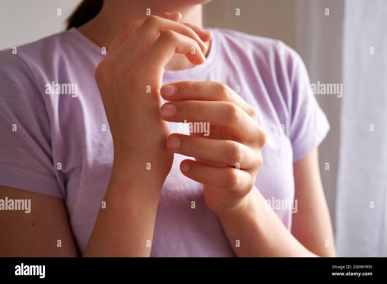 Teenage girl practicing EFT or emotional freedom technique - tapping on ...