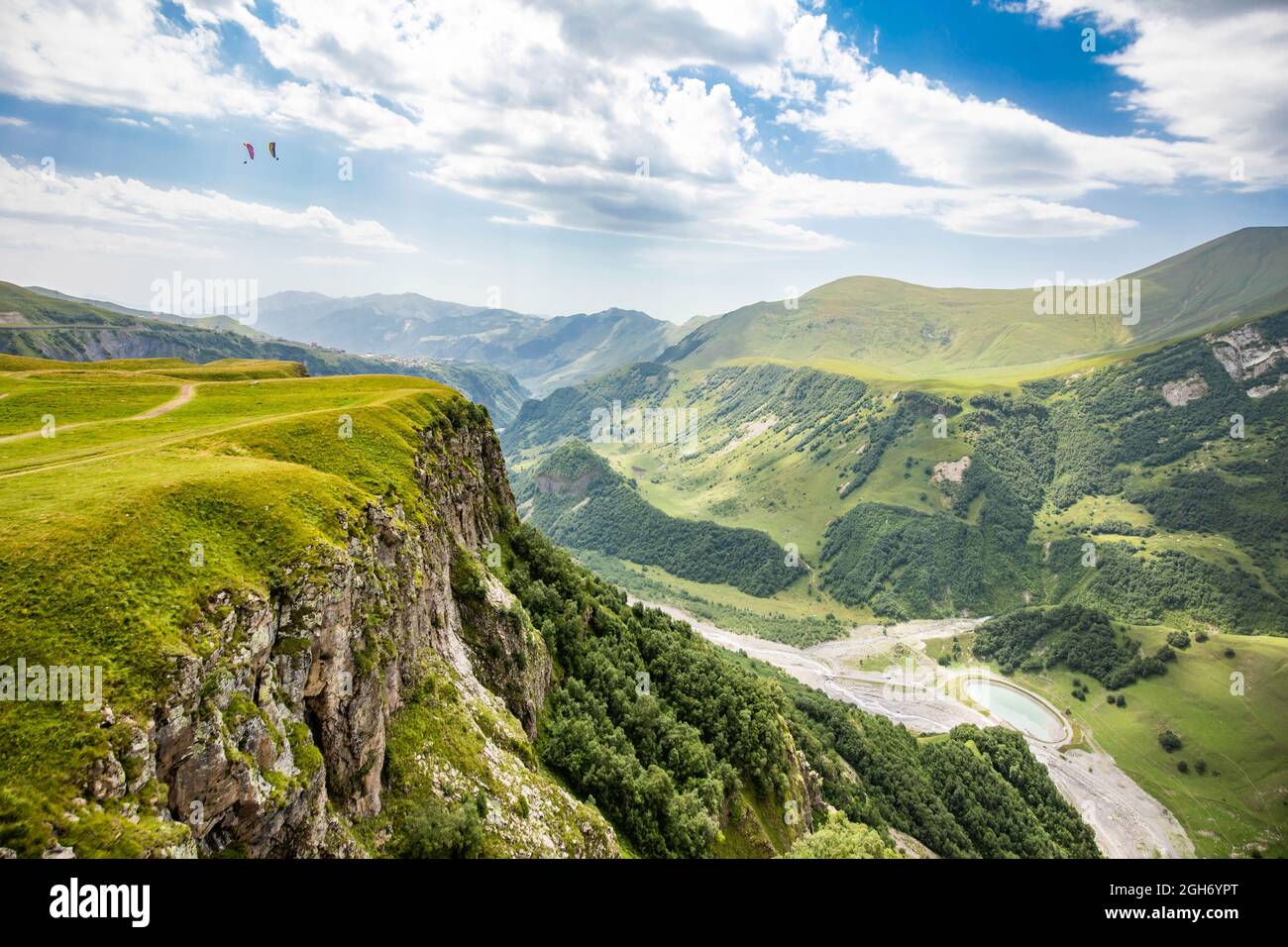 Scenic view at Gudauri View Point monument with paragliding parachutes ...