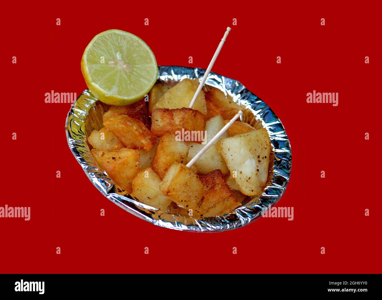 Fresh Aloo Chaat or Potato Chaat served in paper plate with lemon ...