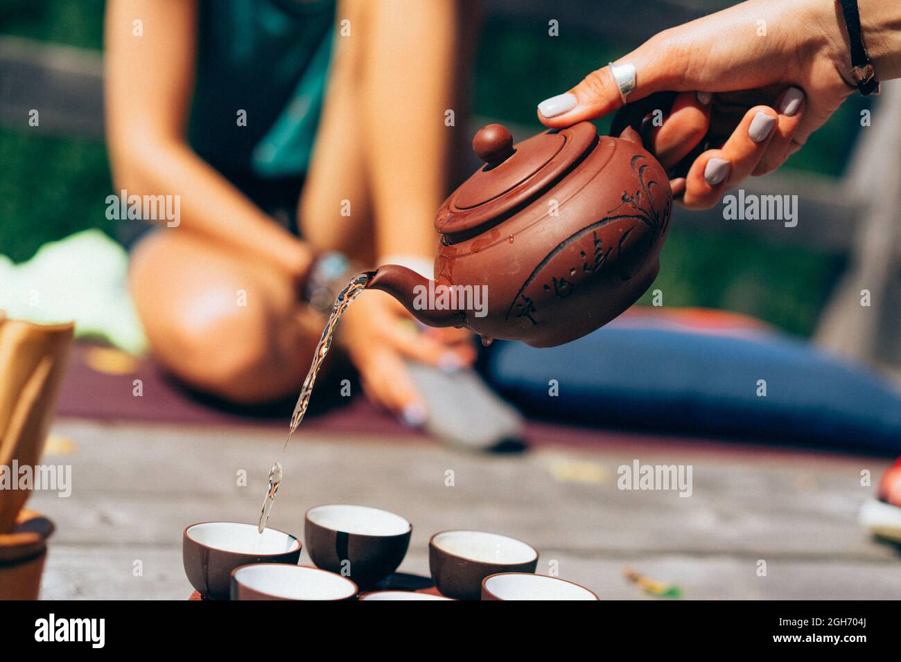 Tea ceremony, Woman pouring traditionally prepared tea Stock Photo - Alamy