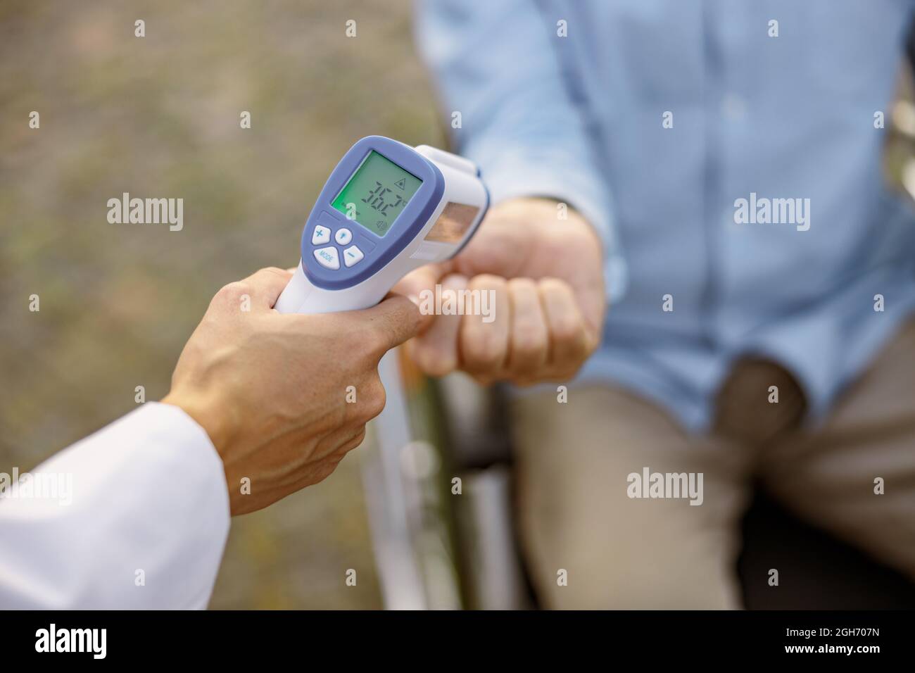 Close up shot of medical infrared thermometer in a hand of doctor ...