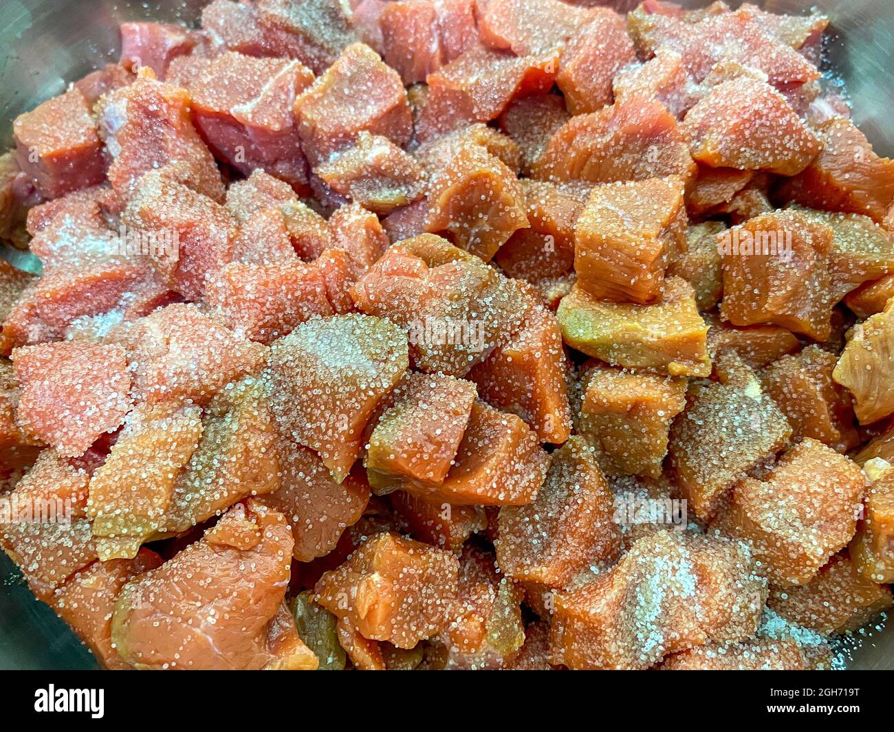 Meat cut into morsel sized pieces in the pot Stock Photo - Alamy