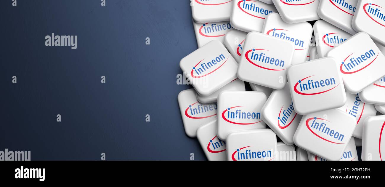 Logos of the German semiconductor manufacturer Infineon on a heap on a ...