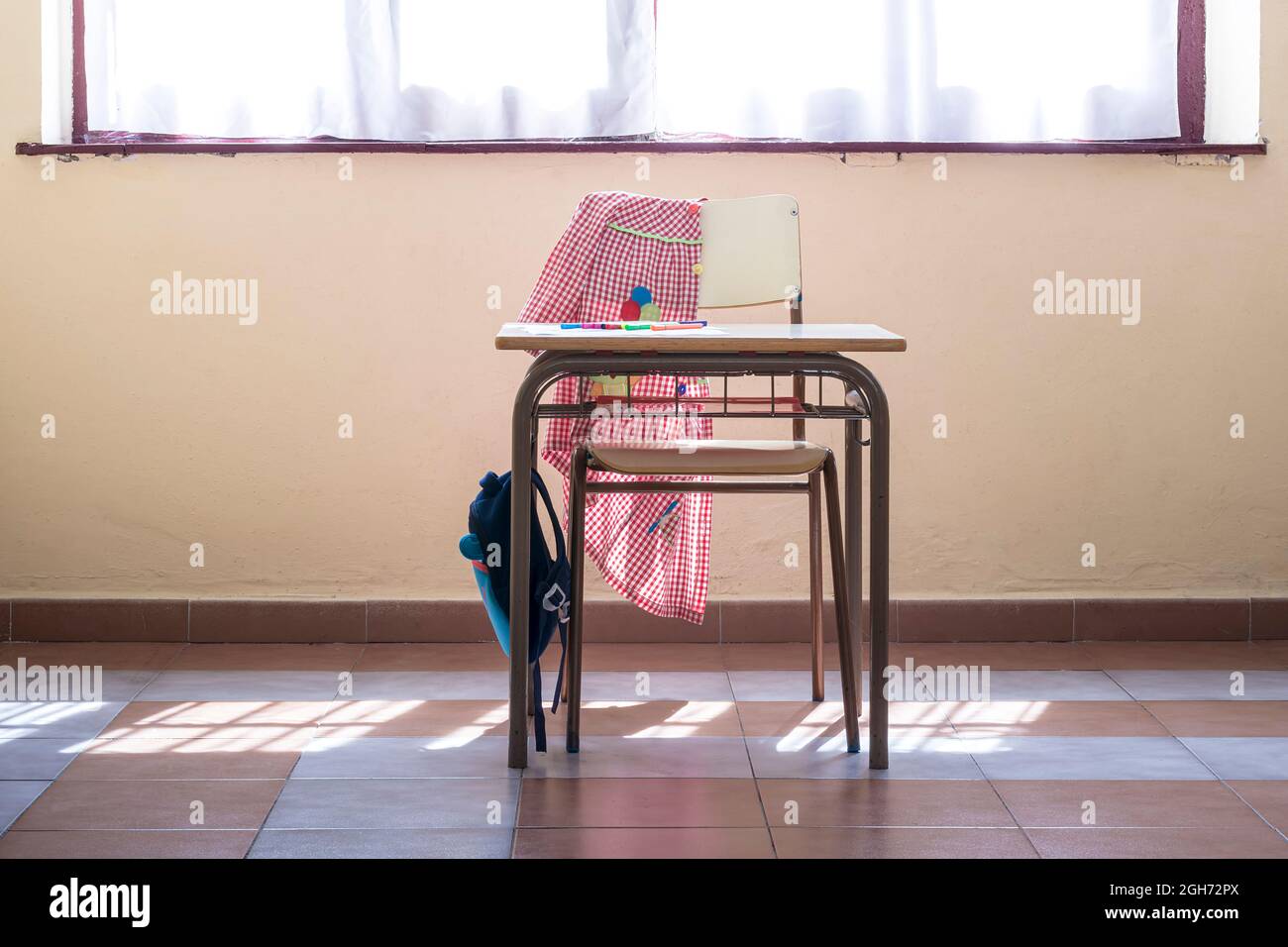 Photograph of a desk and chair in a primary classroom where you can see ...