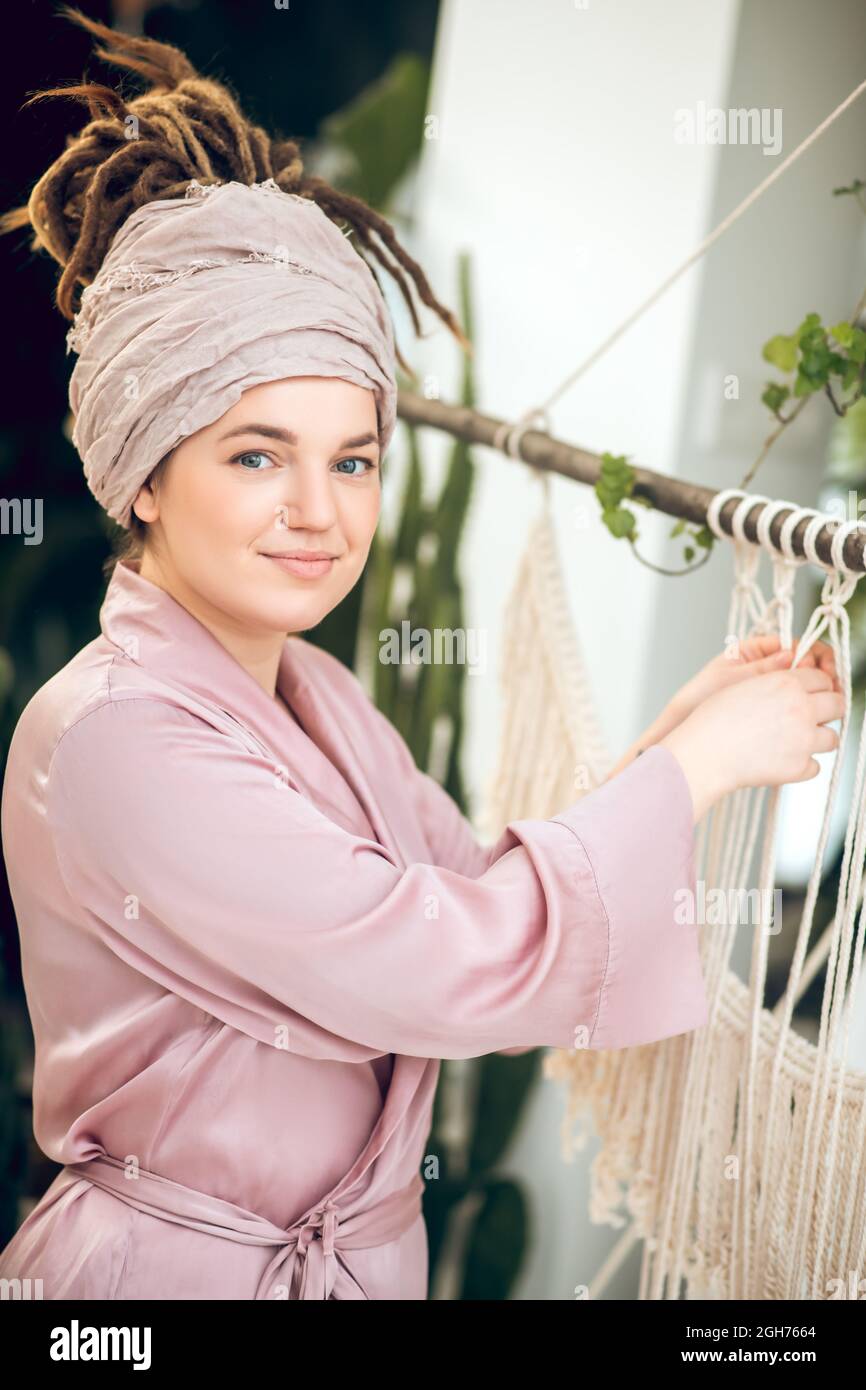 Pretty woman in silk robe doing handicraft Stock Photo - Alamy