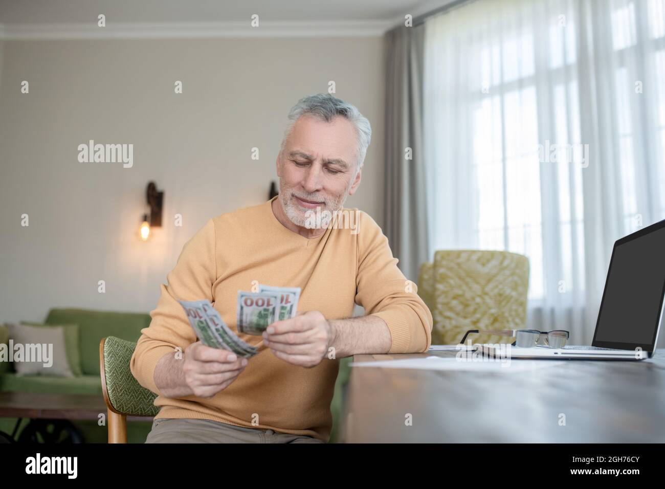 Mature adult man counting dollars hi-res stock photography and images ...