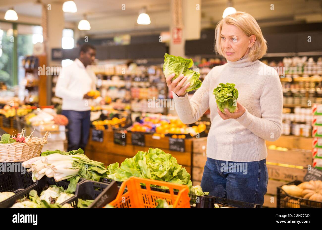 Woman choosing vegetables in hi-res stock photography and images - Alamy