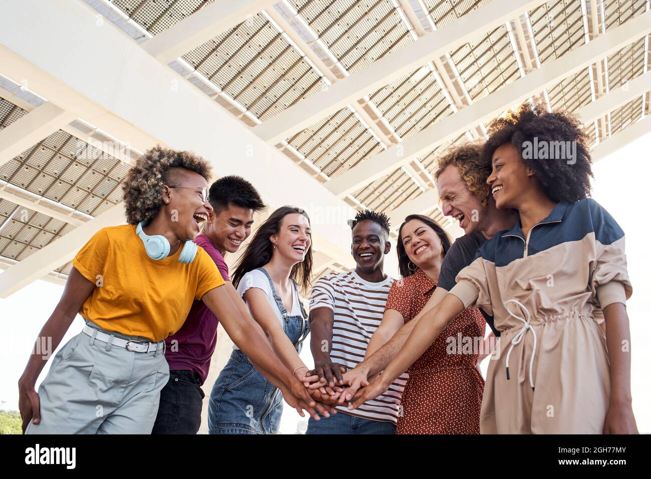 Group of friends stacking hand and happy to be together. Multiethnic ...