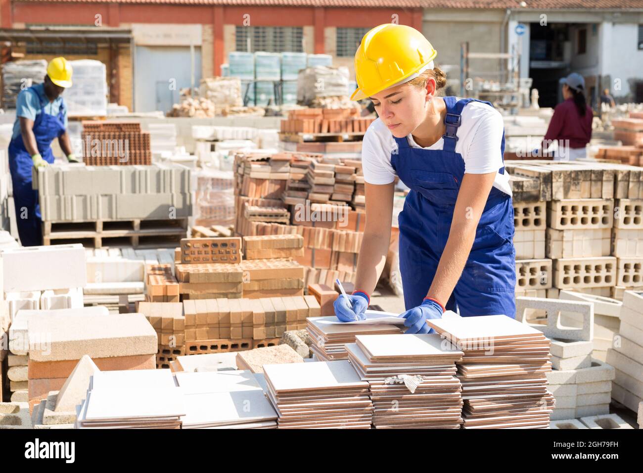 Girl worker keeps records of ceramic tiles Stock Photo - Alamy