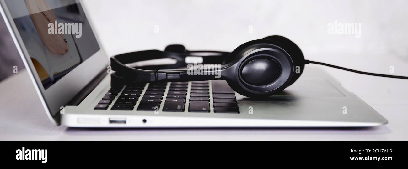 Laptop computer and headphone on desk, e-learning online, webinar for ...
