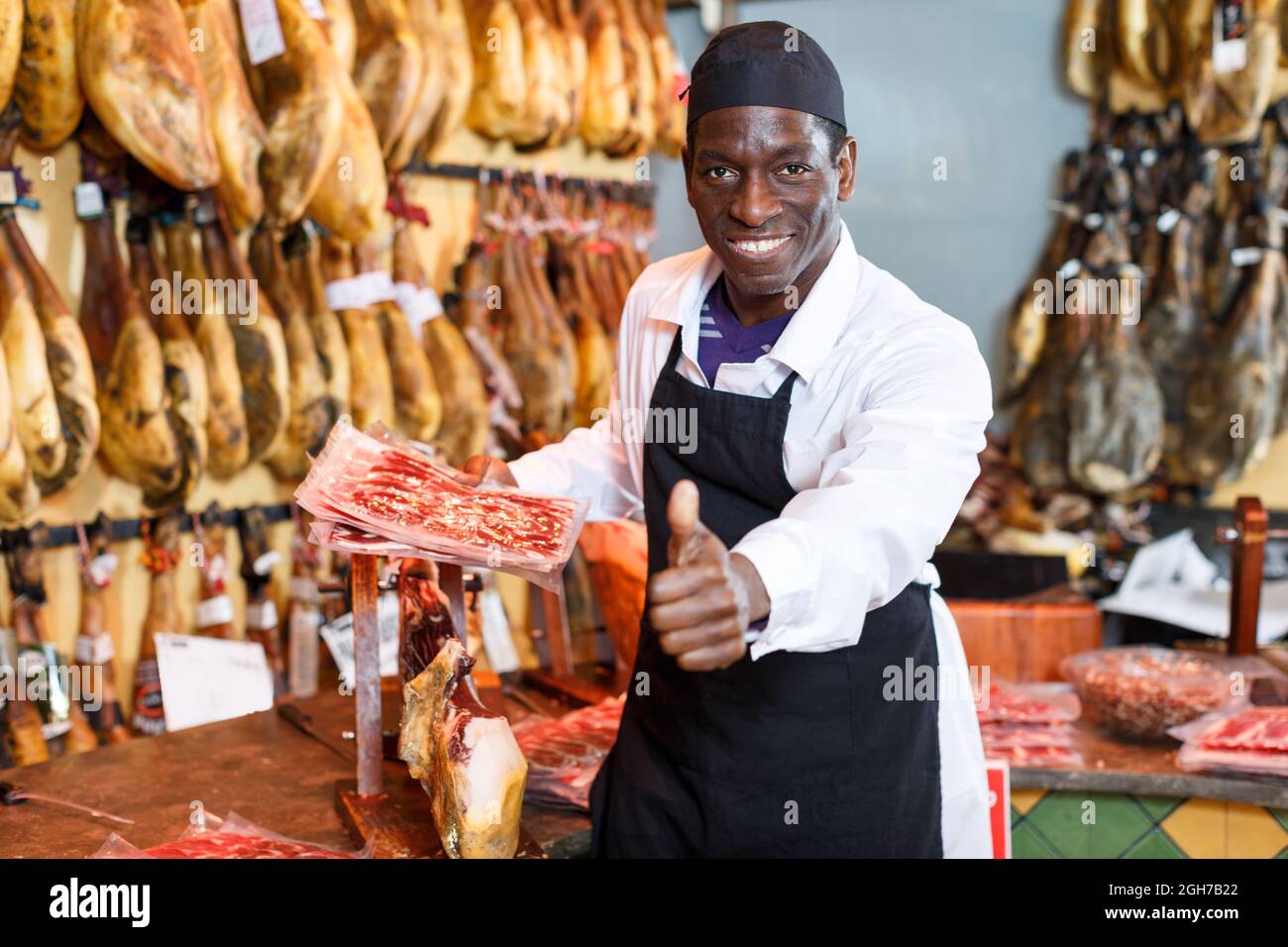 Butcher shop owner giving thumbs up Stock Photo - Alamy