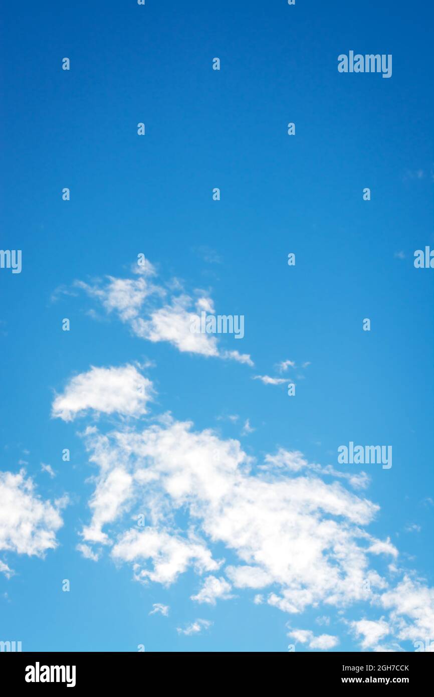 Background with blue sky and small white clouds at the bottom in ...