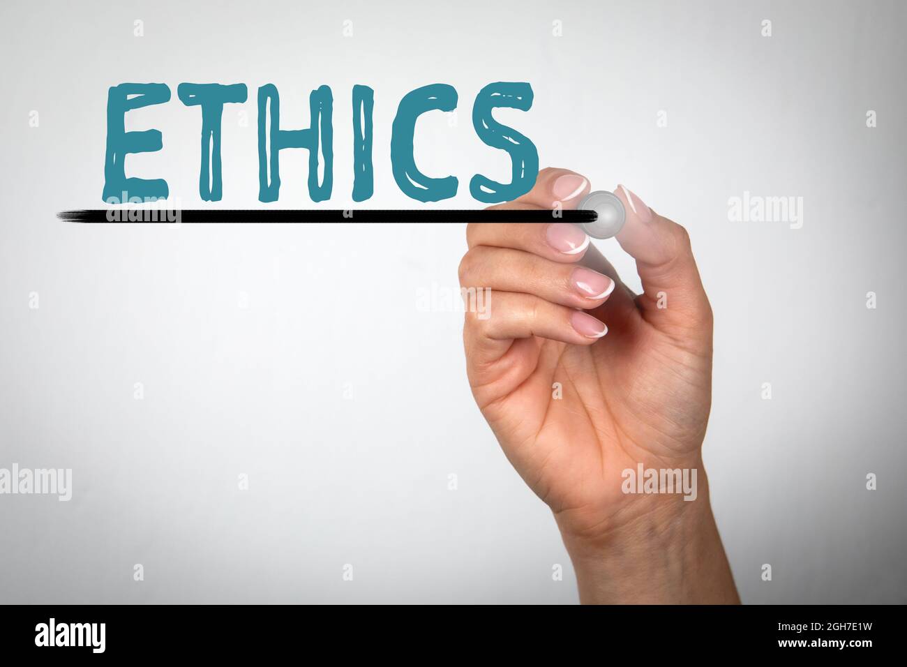 Ethics, business concept. Woman's hand with a pen writes on the screen ...