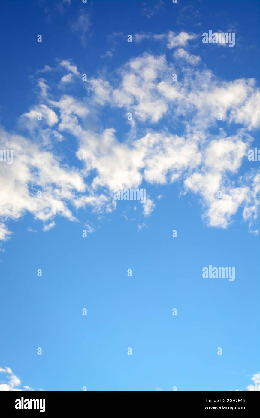Background with blue sky and white clouds from above in vertical format ...