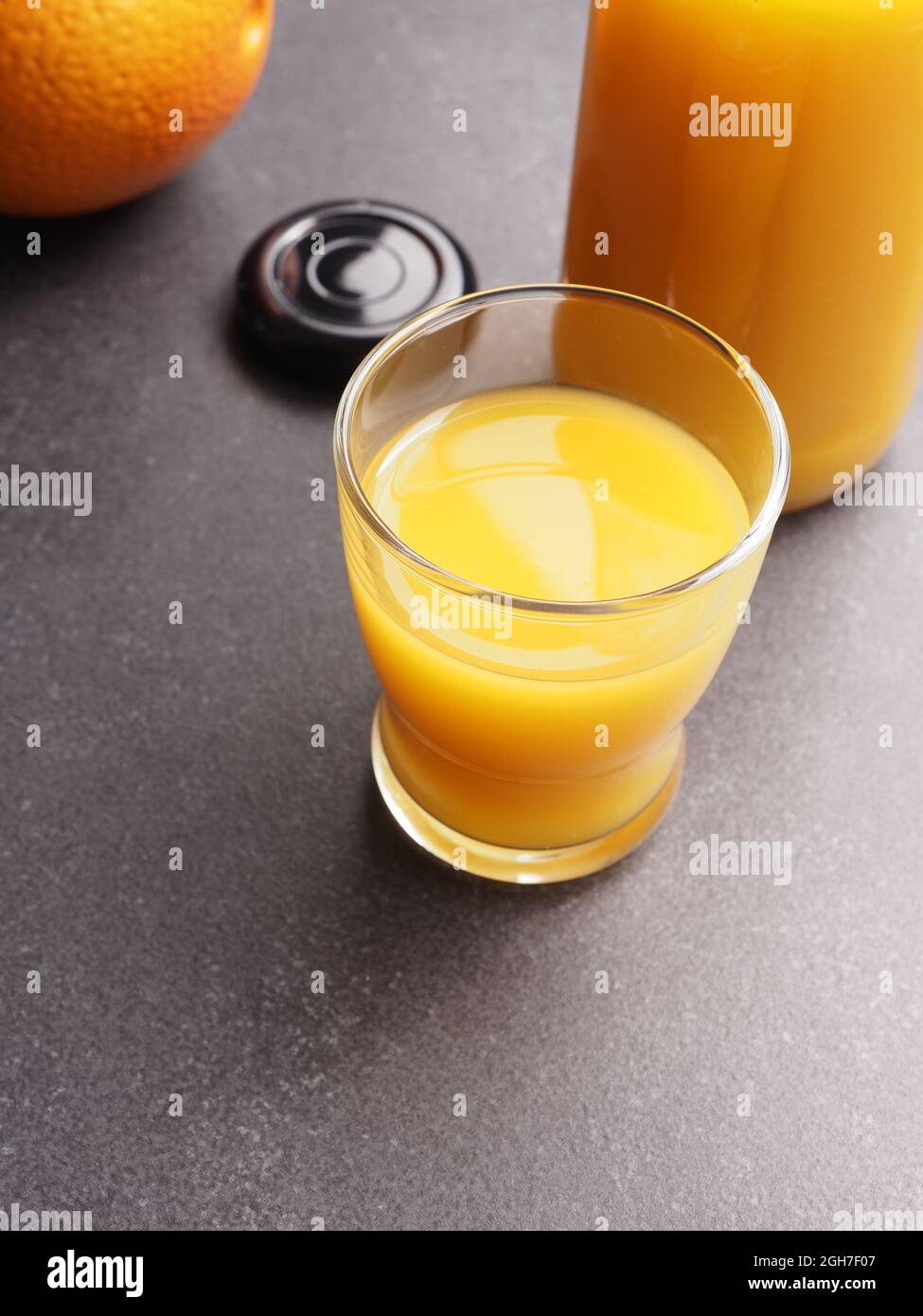 Organic orange juice on a stone table, space for text, view from above ...