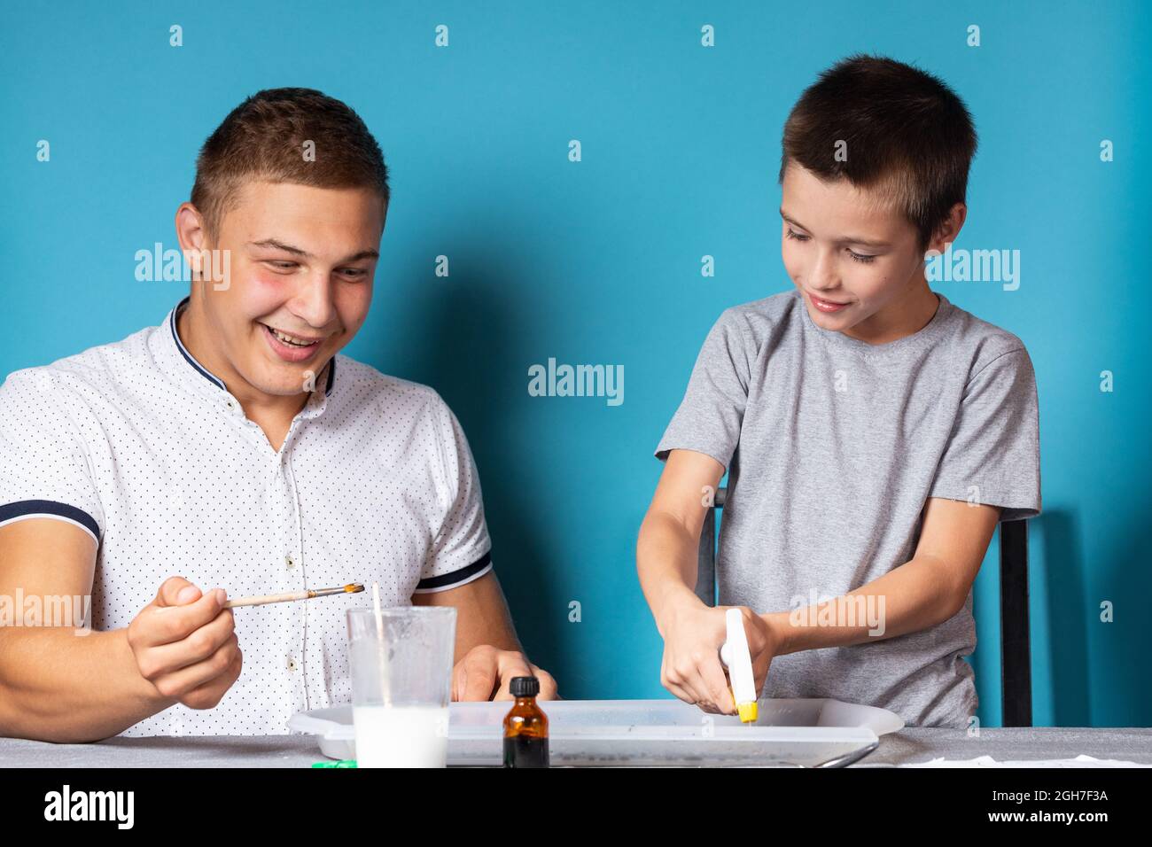 Dad and son are conducting chemical experiments, observing the change ...