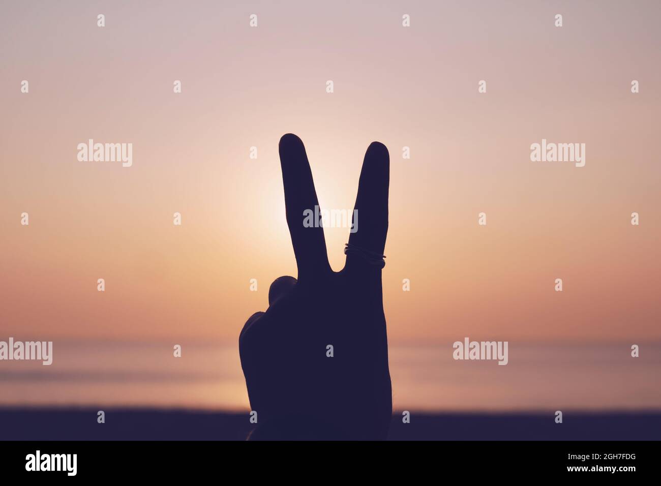 Peace out or fighting metaphor two fingers hand sign in front of a ...