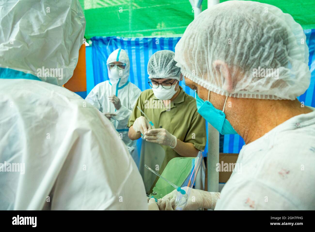 Volunteers working at a COVID testing centre providing free tests for ...