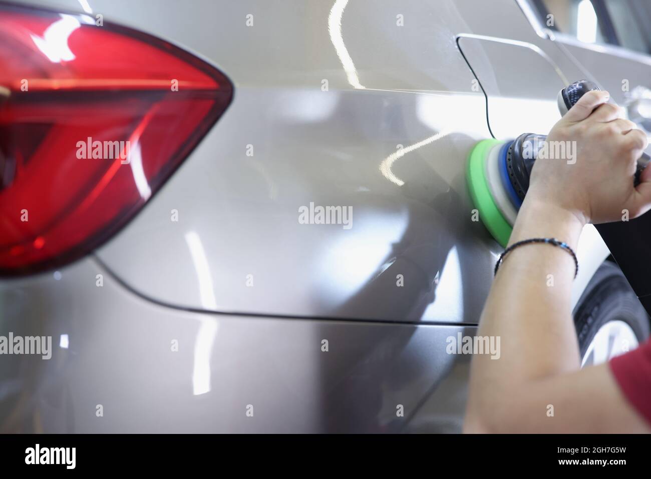 Master polishing car using special machine closeup Stock Photo - Alamy